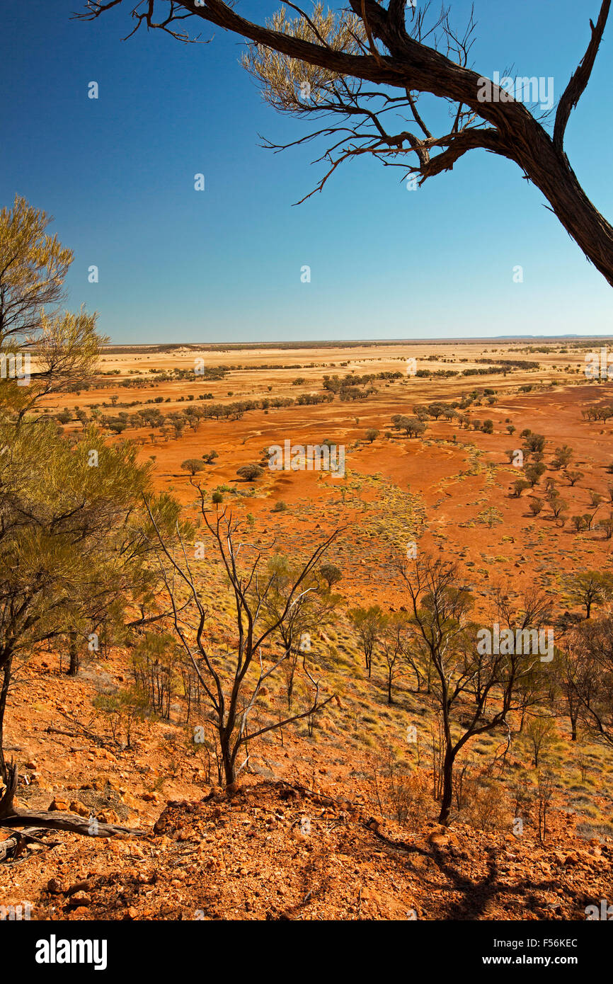 View from hilltop lookout of barren red outback plains stretching to ...