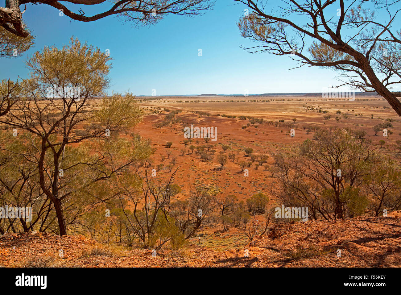 View from hilltop lookout of barren red outback plains stretching to ...