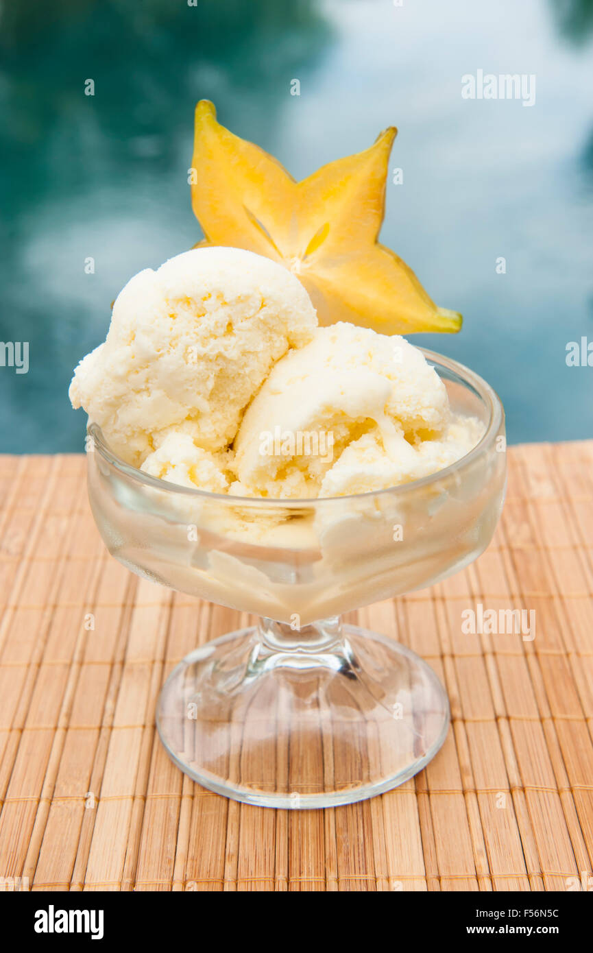 Bowl of starfruit ice cream outside by the pool Stock Photo - Alamy