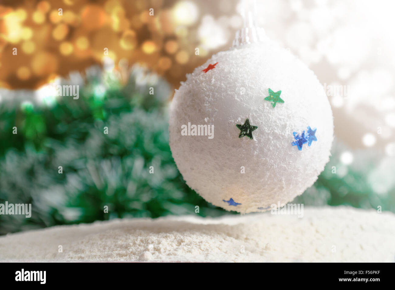snowy white Christmas bauble above the clear snow Stock Photo - Alamy