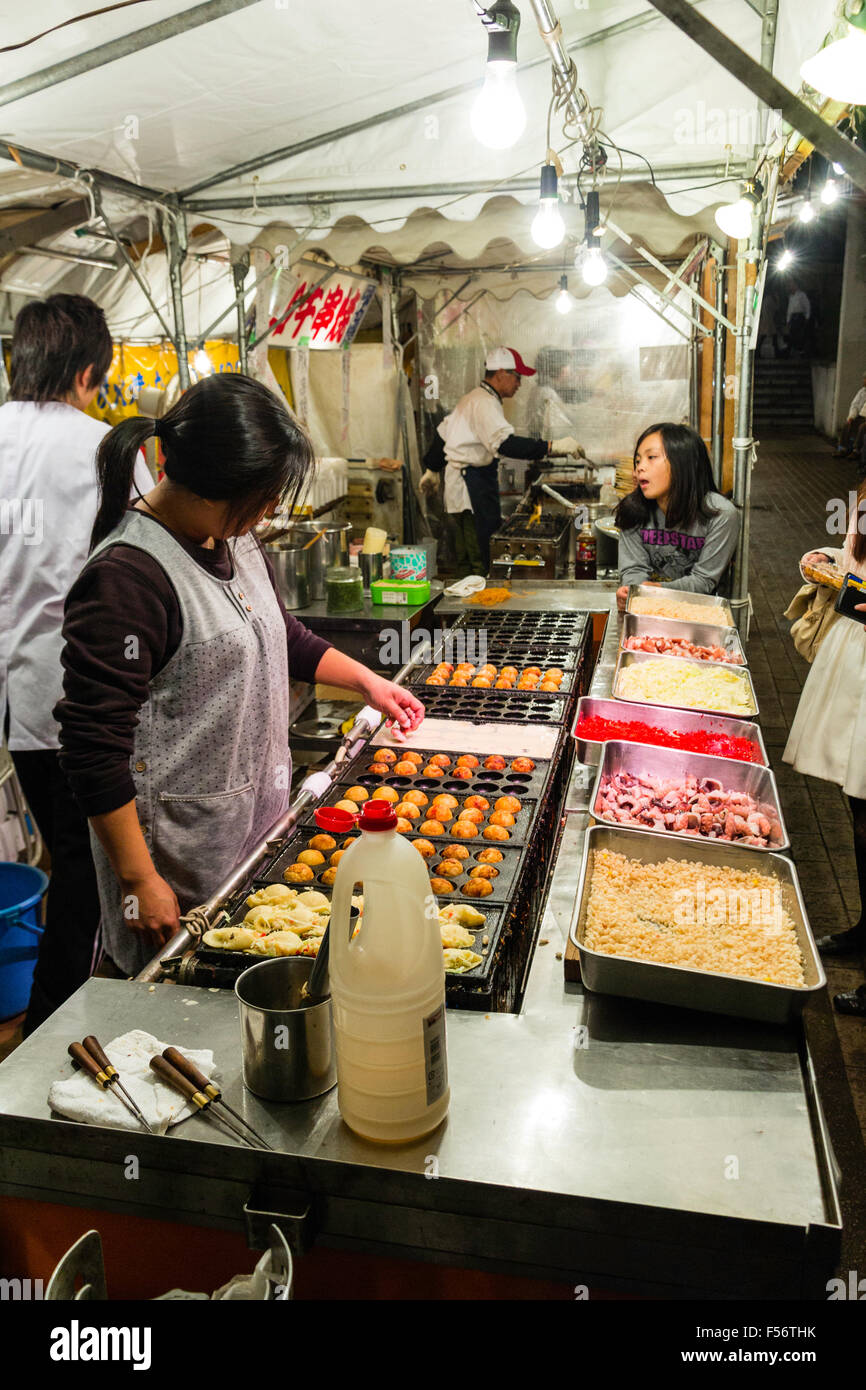 Kobe. Night-time. Yatai, food stall selling Octopus balls. Side view ...