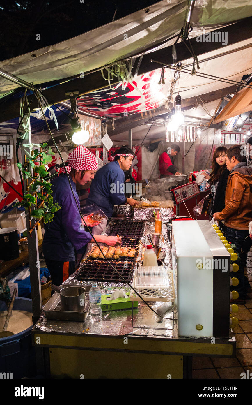 Kobe. Night-time. Yatai, food stall selling Octopus balls. Side view ...