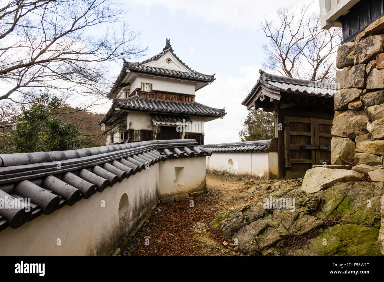 Japan, Takahashi. Bitchu Matsuyama castle. Low dobei white plaster wall ...