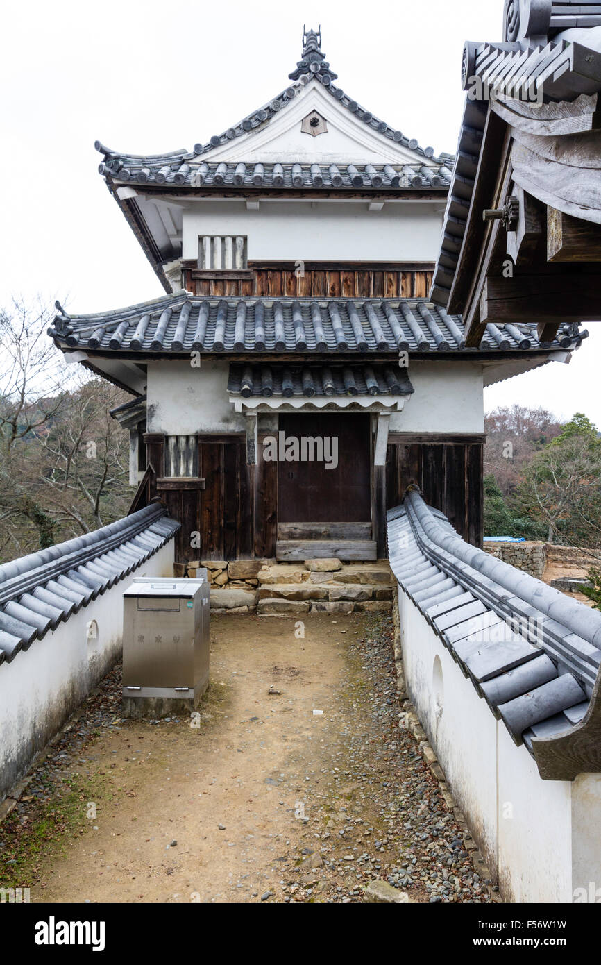 Japan, Takahashi. Bitchu Matsuyama castle. Low dobei white plaster wall ...