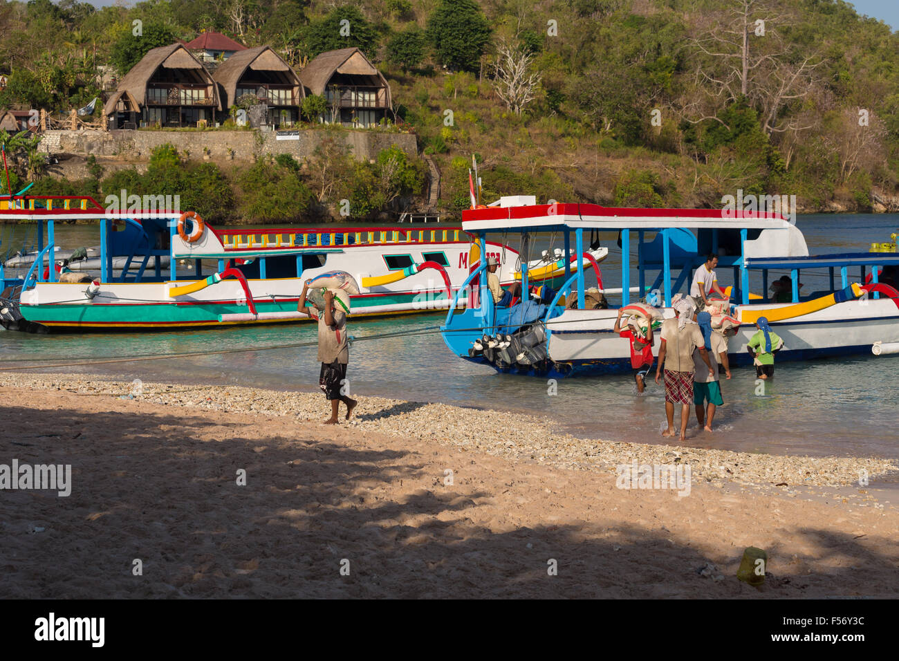 BALI, NUSA PENIDA ISLAND, INDONESIA - JULY 29.2015: Men transports ...