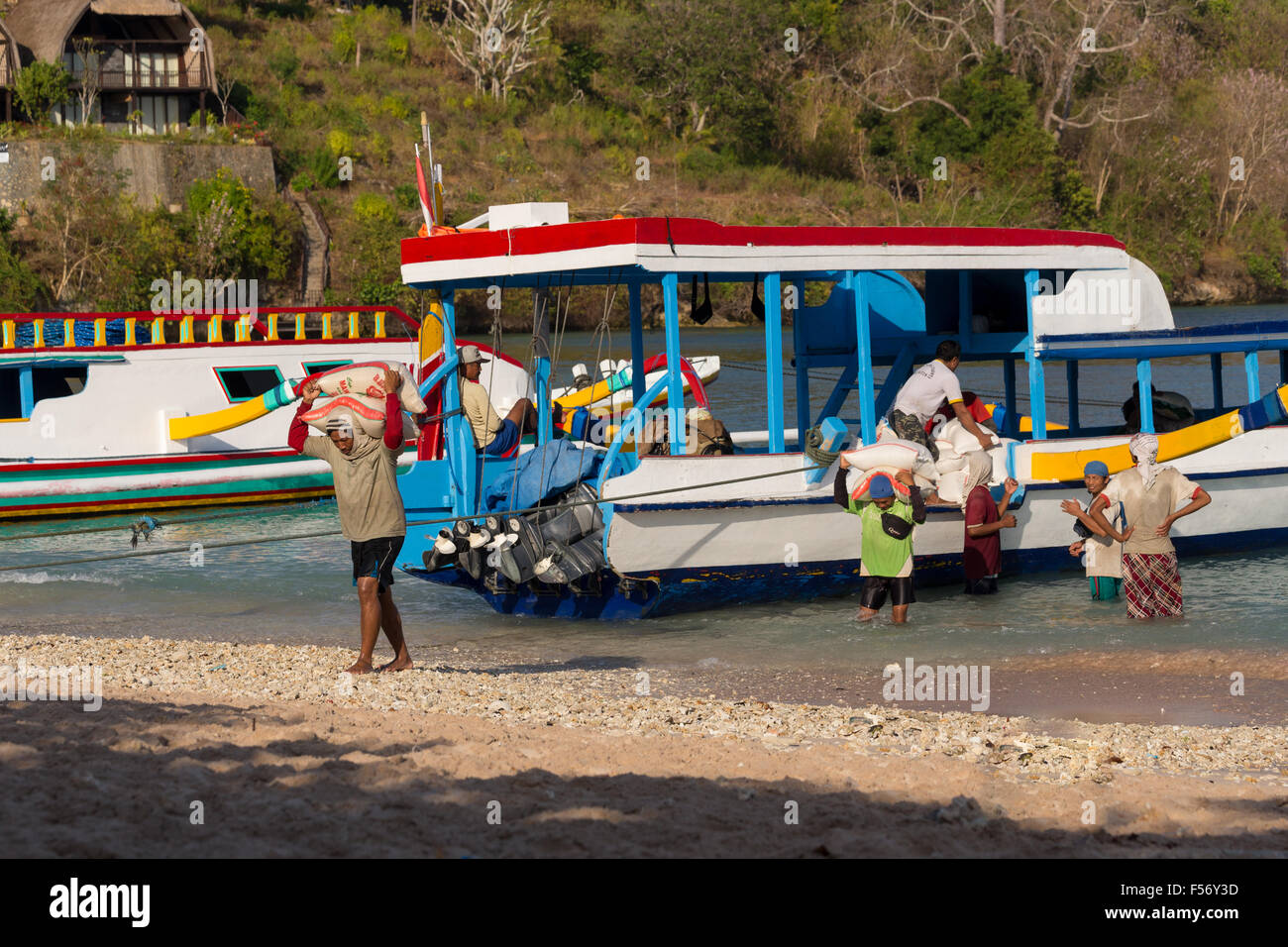 BALI, NUSA PENIDA ISLAND, INDONESIA - JULY 29.2015: Men transports ...