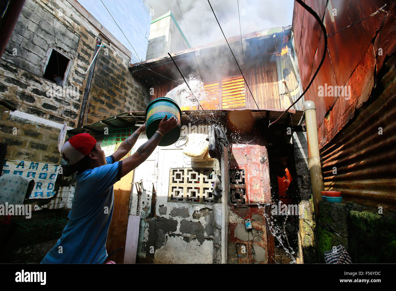 Paranaque City, Philippines. 29th Oct, 2015. A resident pours a bucket ...