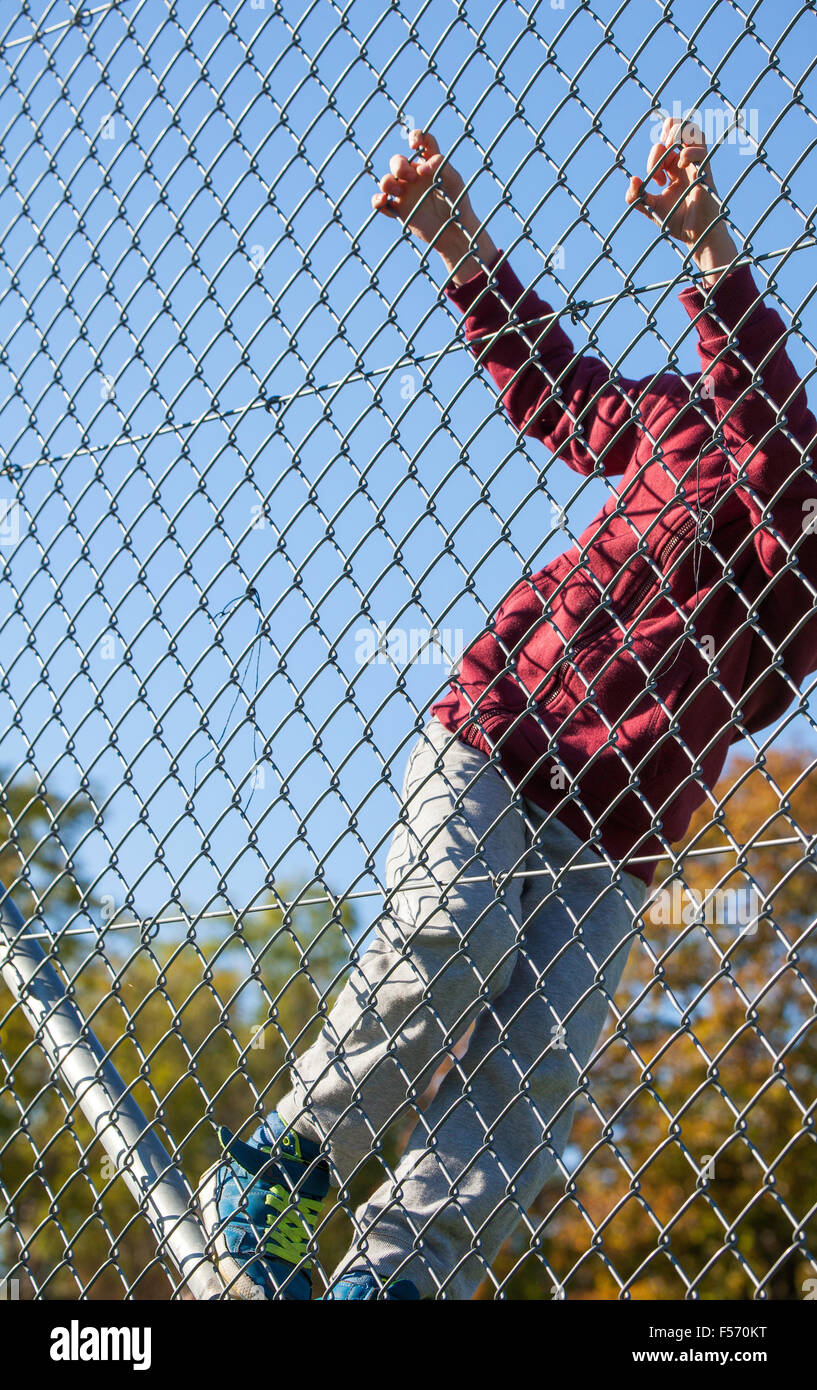 Children climbing a fence hi-res stock photography and images - Alamy