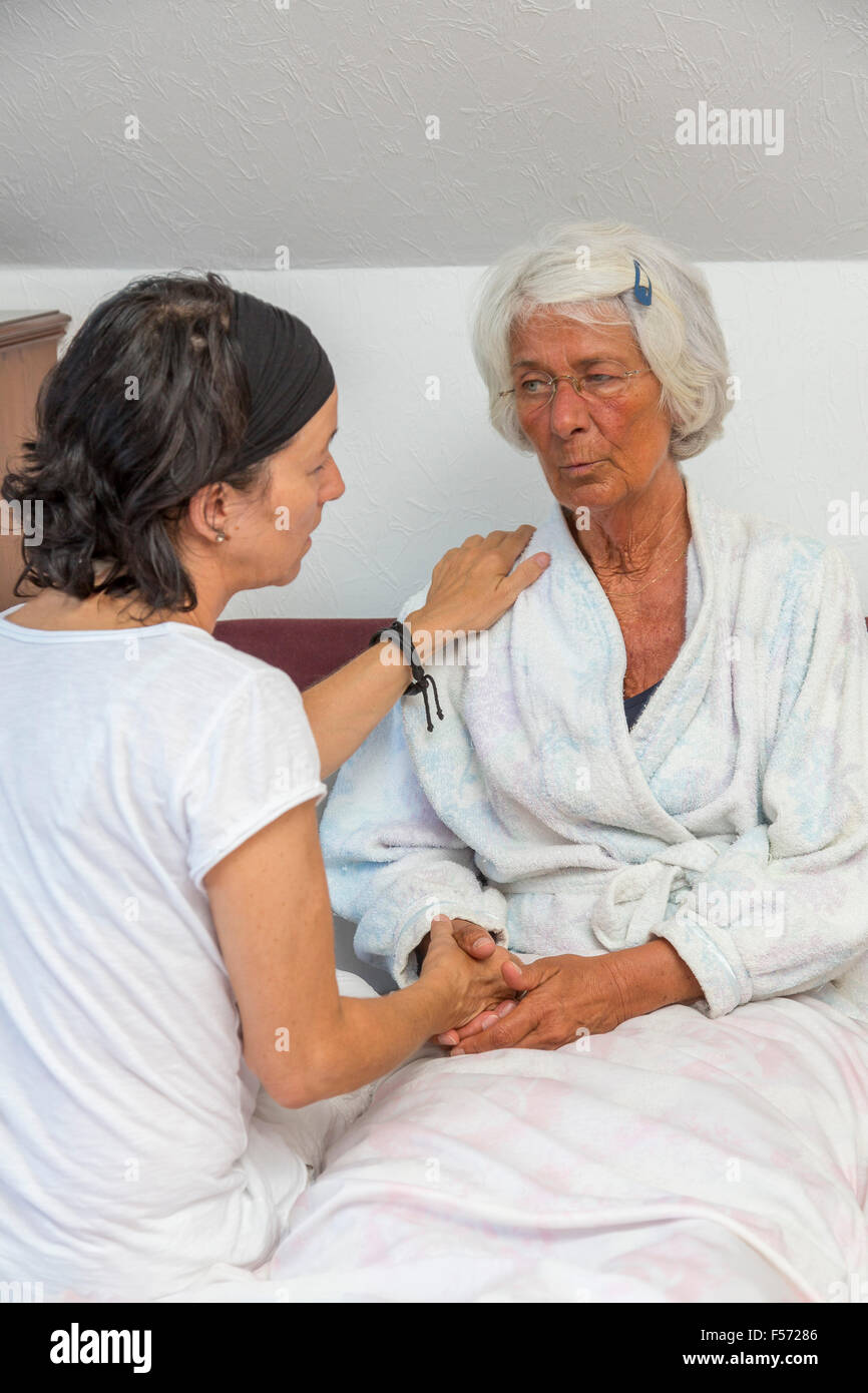 Elderly care at home, Nurse cares for an elderly woman, talking ...