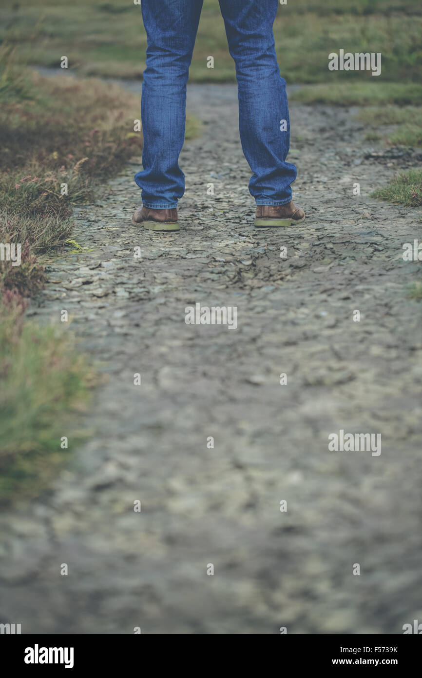 Man's legs standing on cracked ground Stock Photo - Alamy