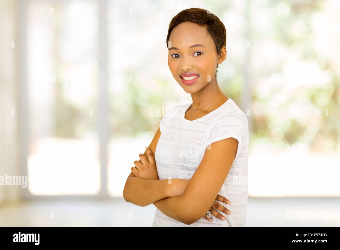 beautiful young African woman with arms crossed Stock Photo - Alamy