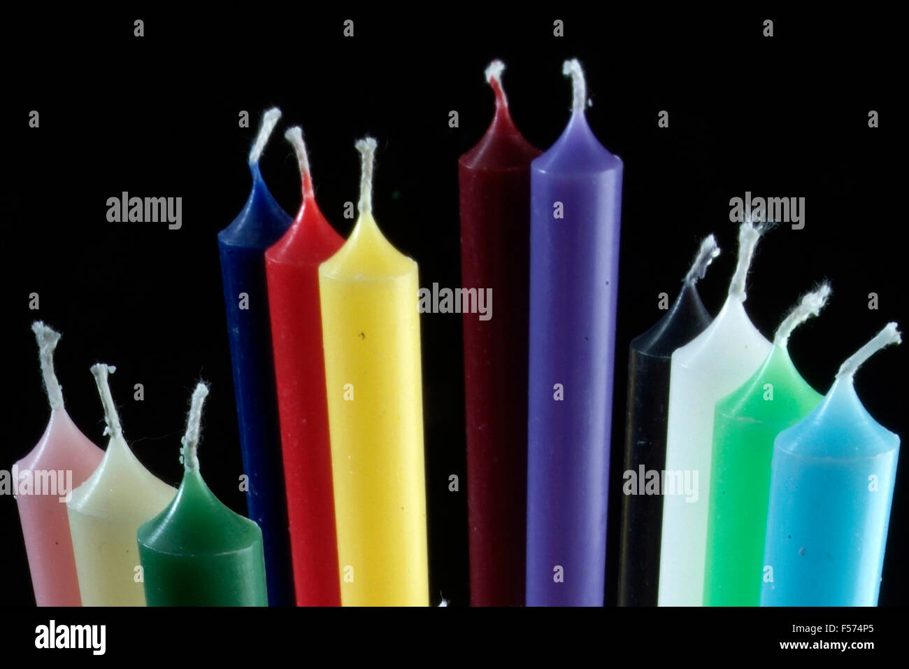 group of colorful cylindrical candles on a black background Stock Photo ...