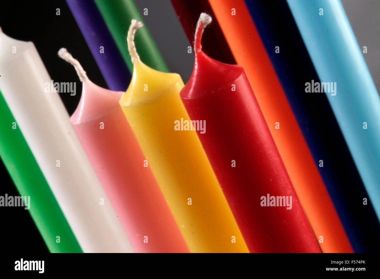 group of colorful cylindrical candles on a black background Stock Photo ...