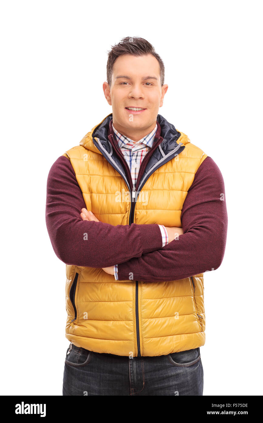 Vertical shot of a casual young man wearing a yellow vest and looking ...