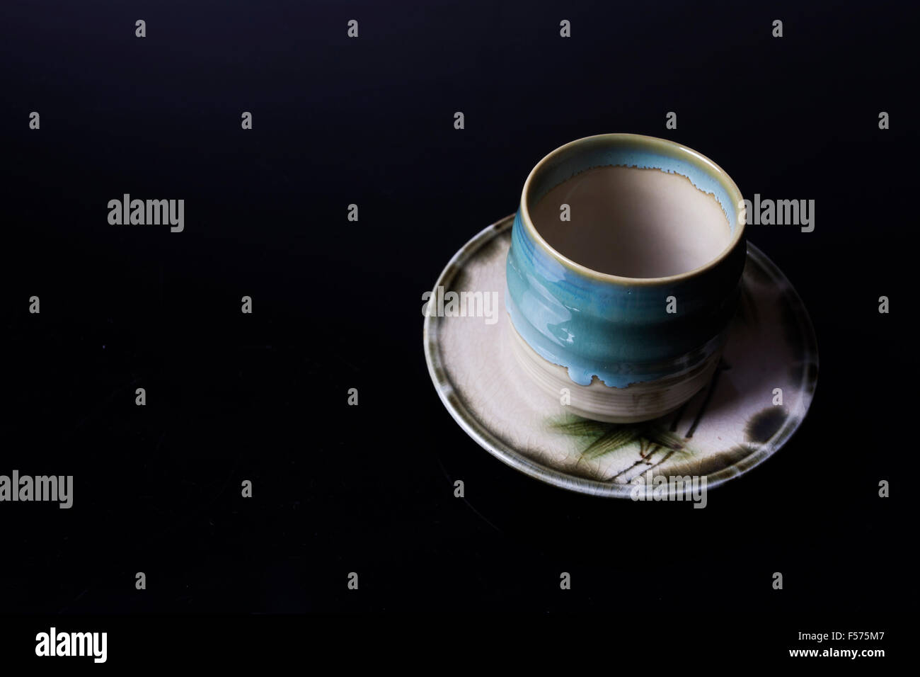 Traditional Japanese pottery isolated on black background Stock Photo ...