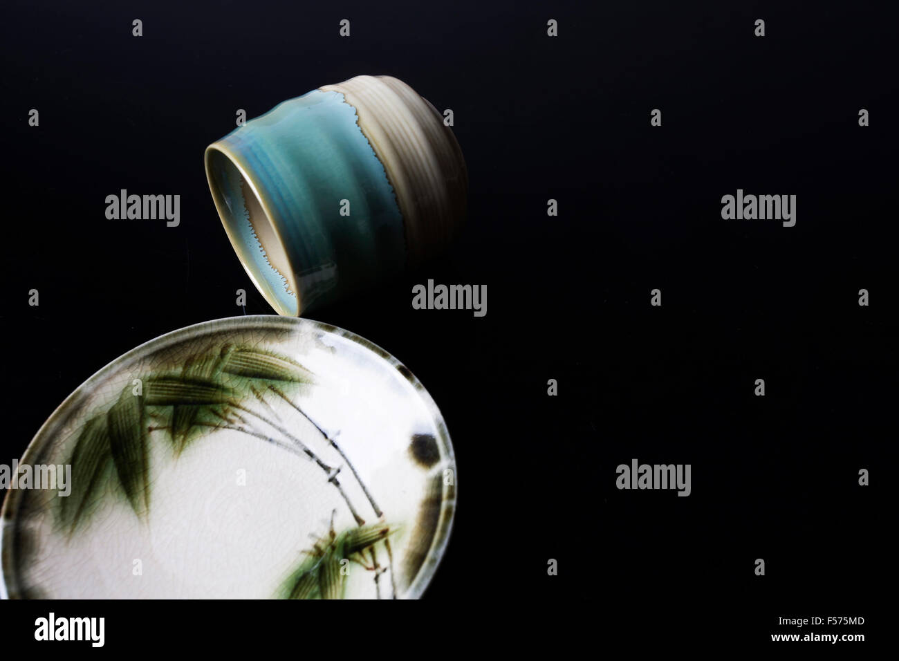 Traditional Japanese pottery isolated on black background Stock Photo ...