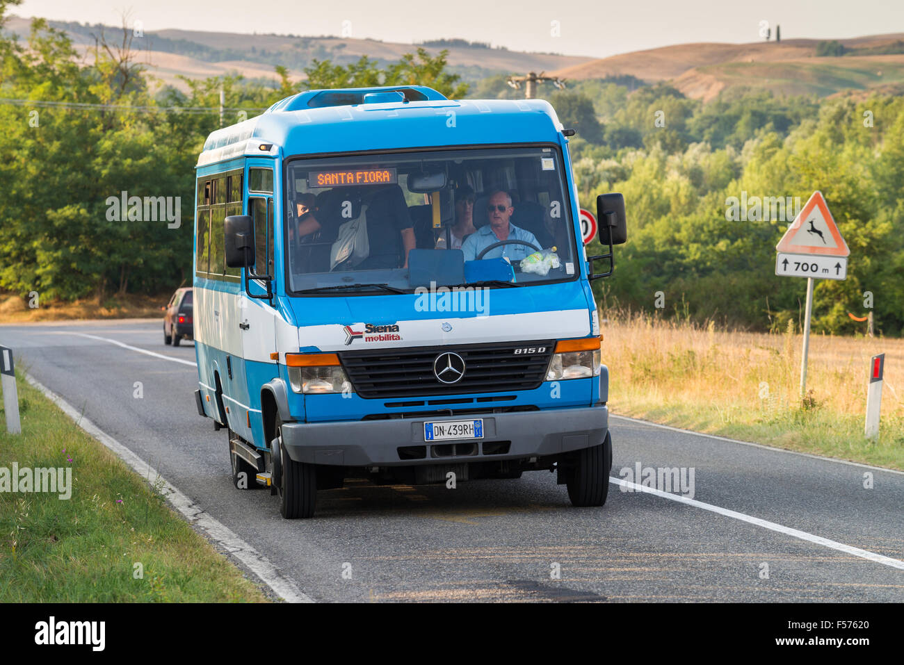 Beautiful landscape in Val d'Orcia with blue public bus, Tuscany, Italy ...
