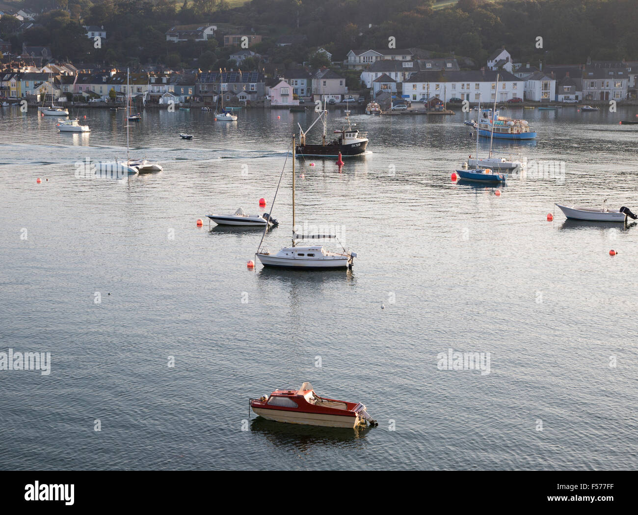 Fishing boat passing yachts at moorings on river fal hi-res stock ...