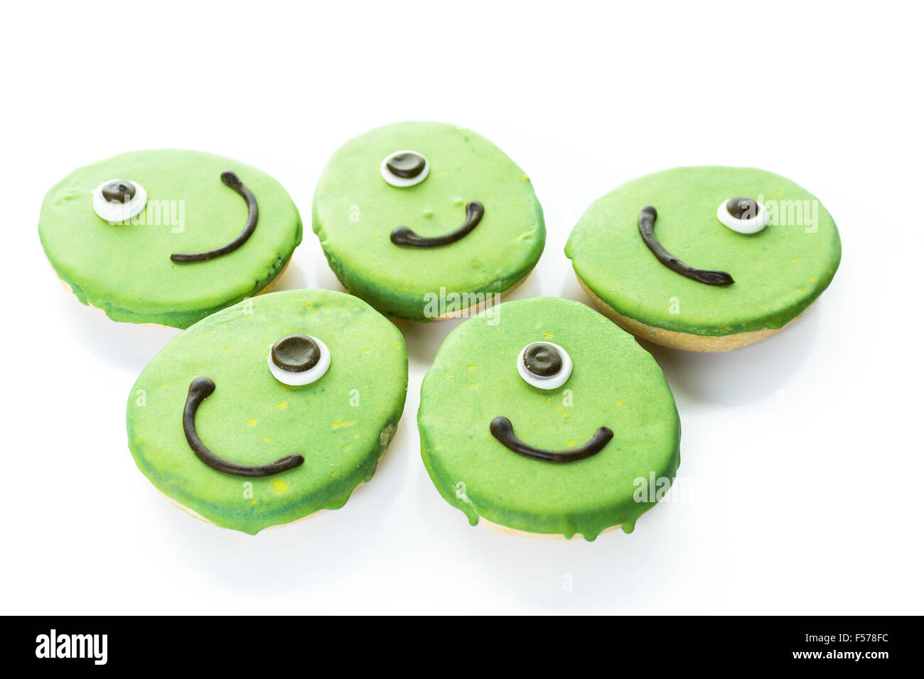 Alien cookies with green icing prepared as Halloween treats Stock Photo ...