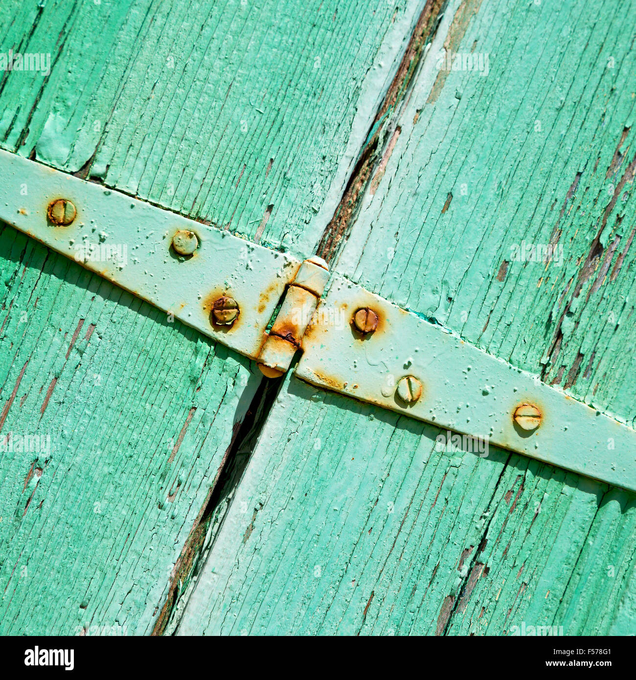 in the old wall a hinged window green wood and rusty metal Stock Photo ...