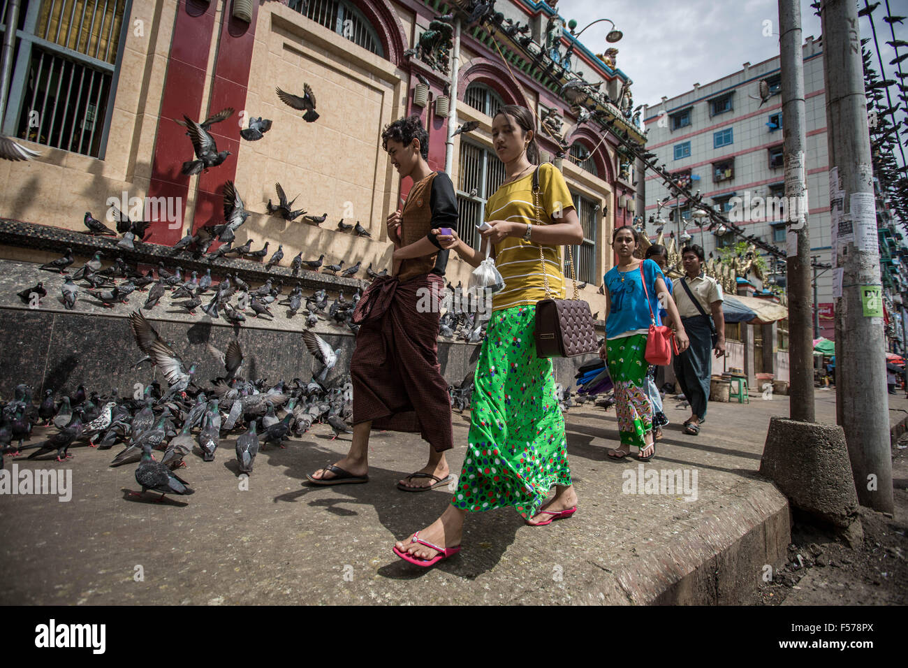 Yangon, Yangon, Myanmar. 29th Oct, 2015. Local burmese people pass by ...