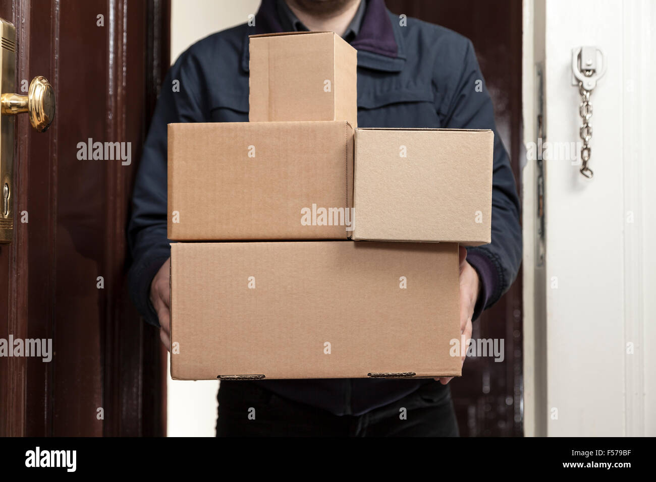 Postman brings a lot packages Stock Photo - Alamy