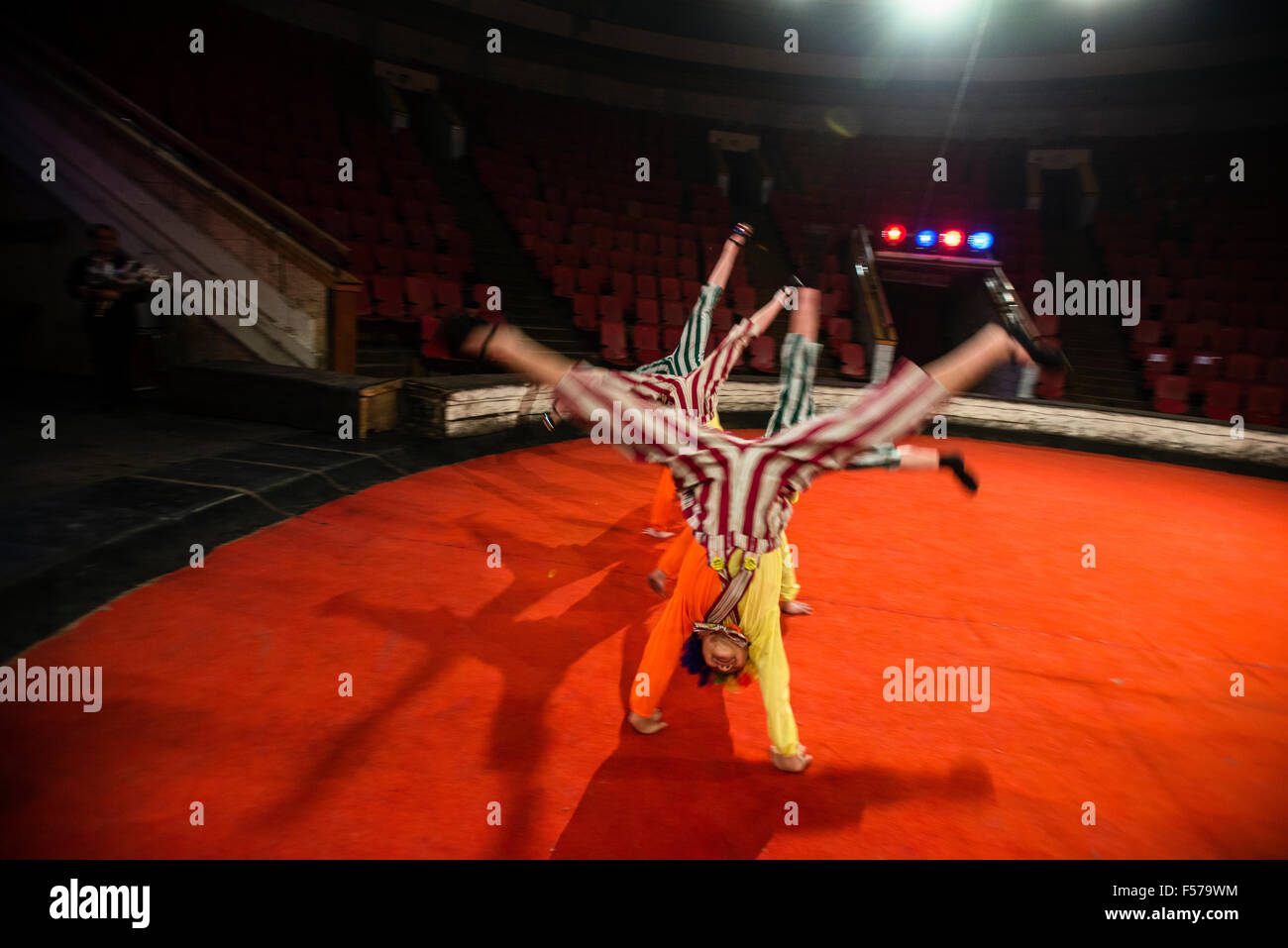 Clowns of children circus studio make somersault during performance at ...
