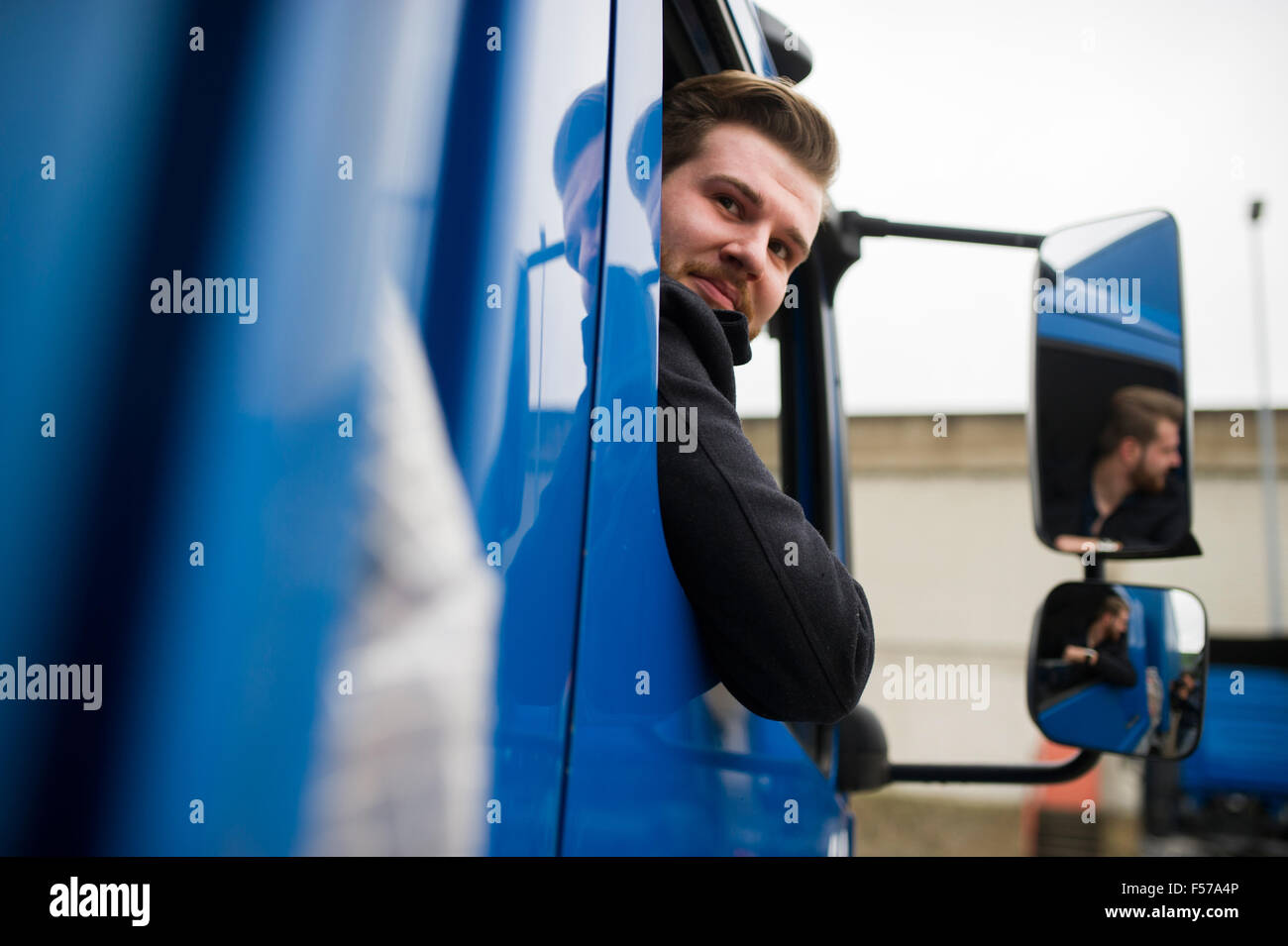 young lorry driver looking in the mirror (MR Stock Photo - Alamy