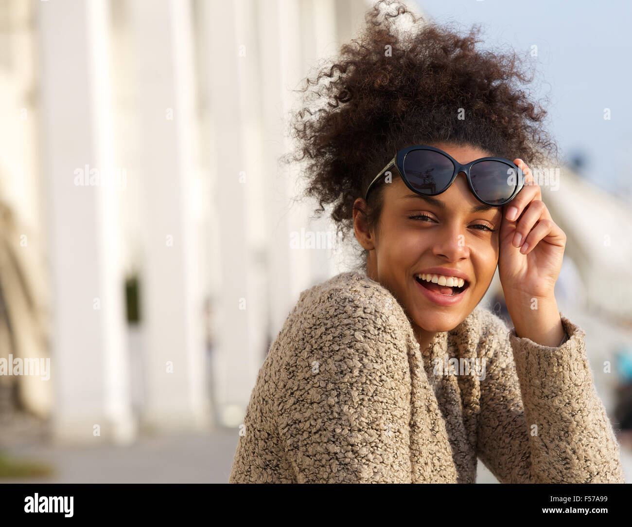 Close up portrait of a cheerful young woman laughing outside Stock ...