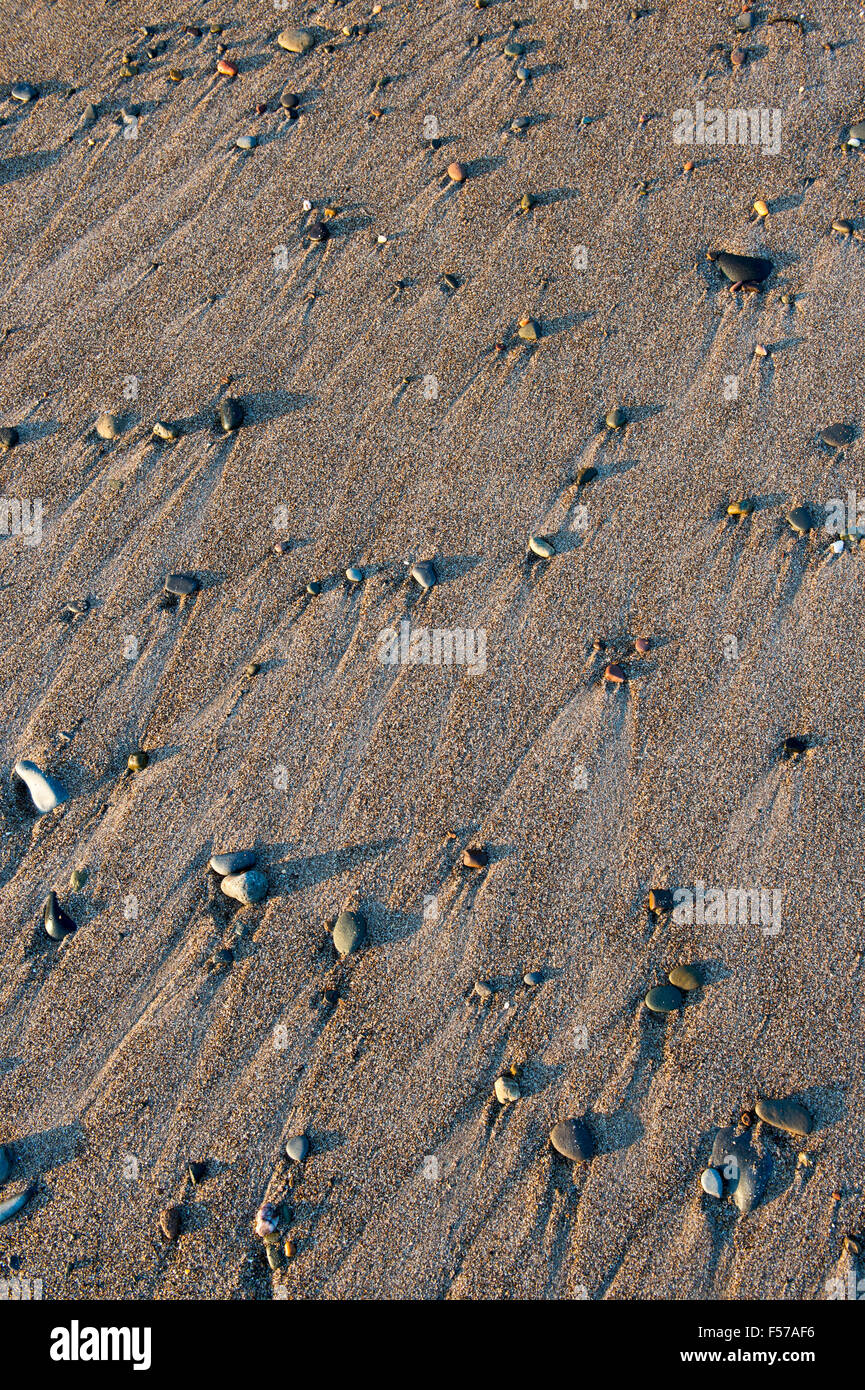 Pebbles on the beach in morning sunlight pattern Stock Photo - Alamy