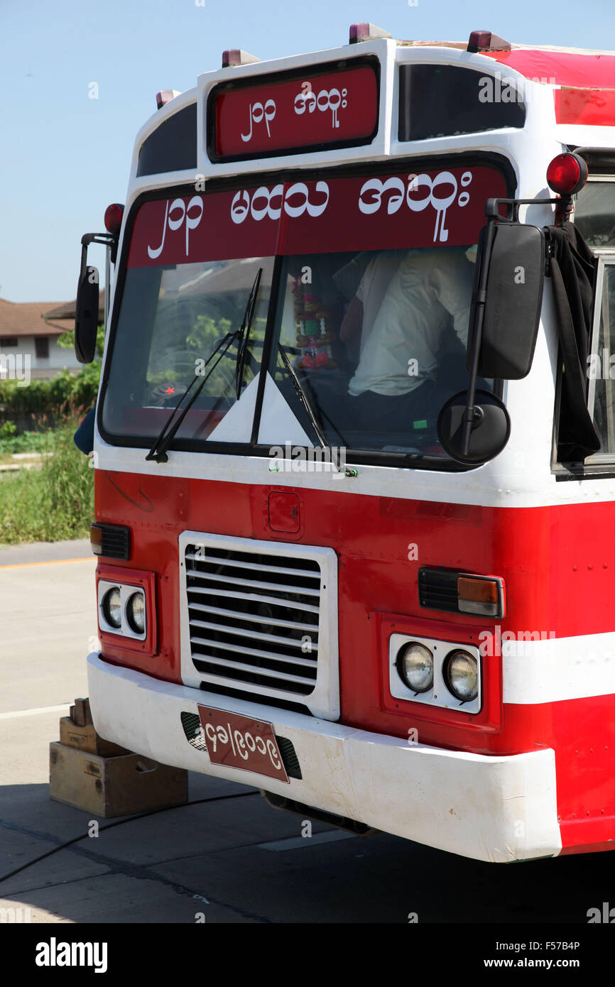 It's a photo of the front of a bus in Myanmar or Burma in red color ...