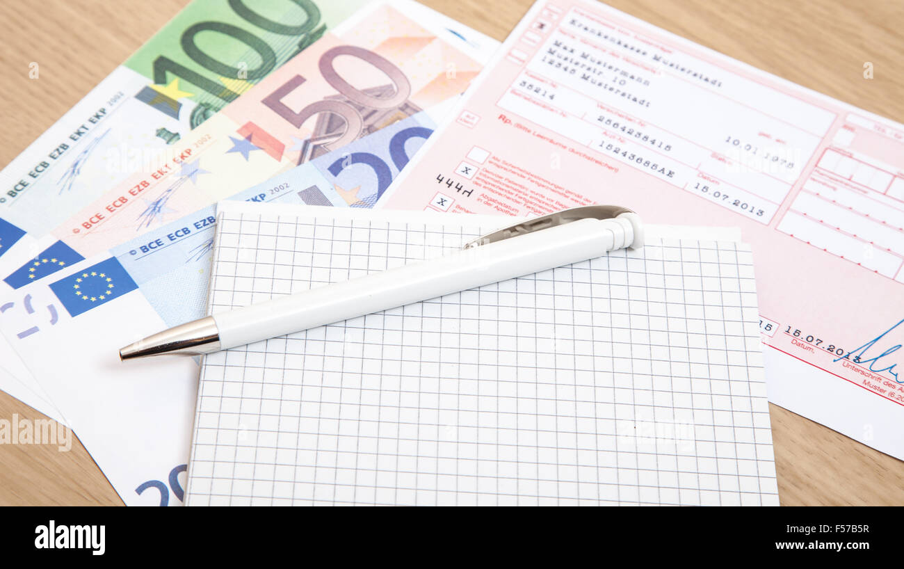 Various euro notes next to notepad on desk Stock Photo - Alamy