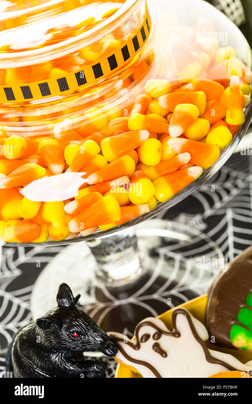 Candy corn in candy jar for Halloween treats Stock Photo - Alamy
