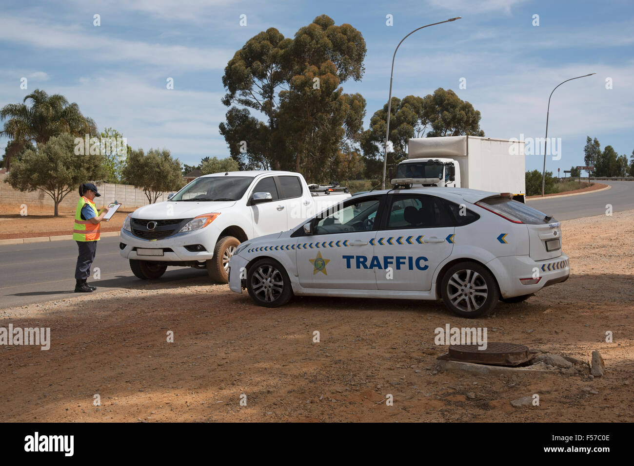 Traffic police taking driver details on roadside during a road block ...
