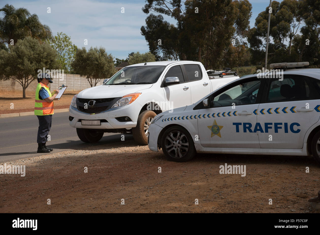 Traffic police taking driver details on roadside during a road block ...