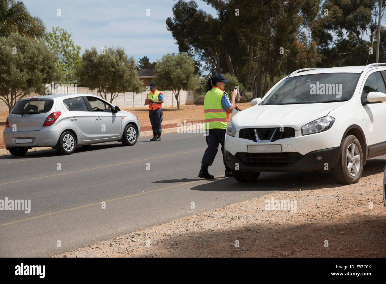 Traffic police taking driver details on roadside during a road block ...