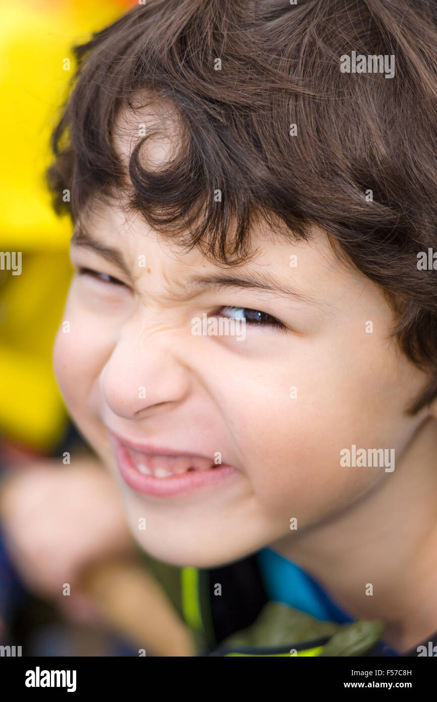 Boy with narrowed eyes Stock Photo - Alamy