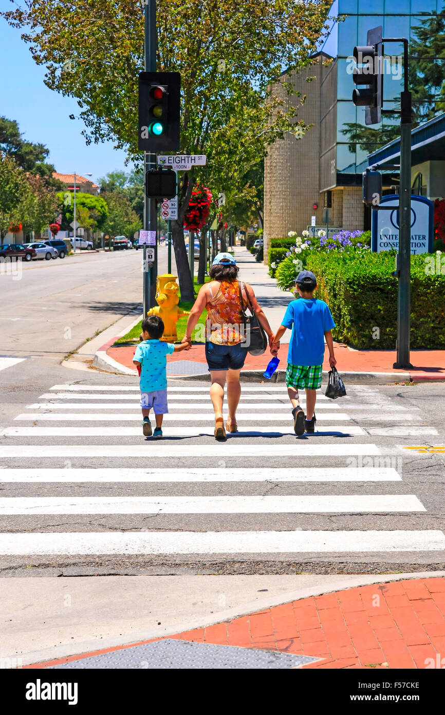 Mother holding children crossing road hi-res stock photography and ...