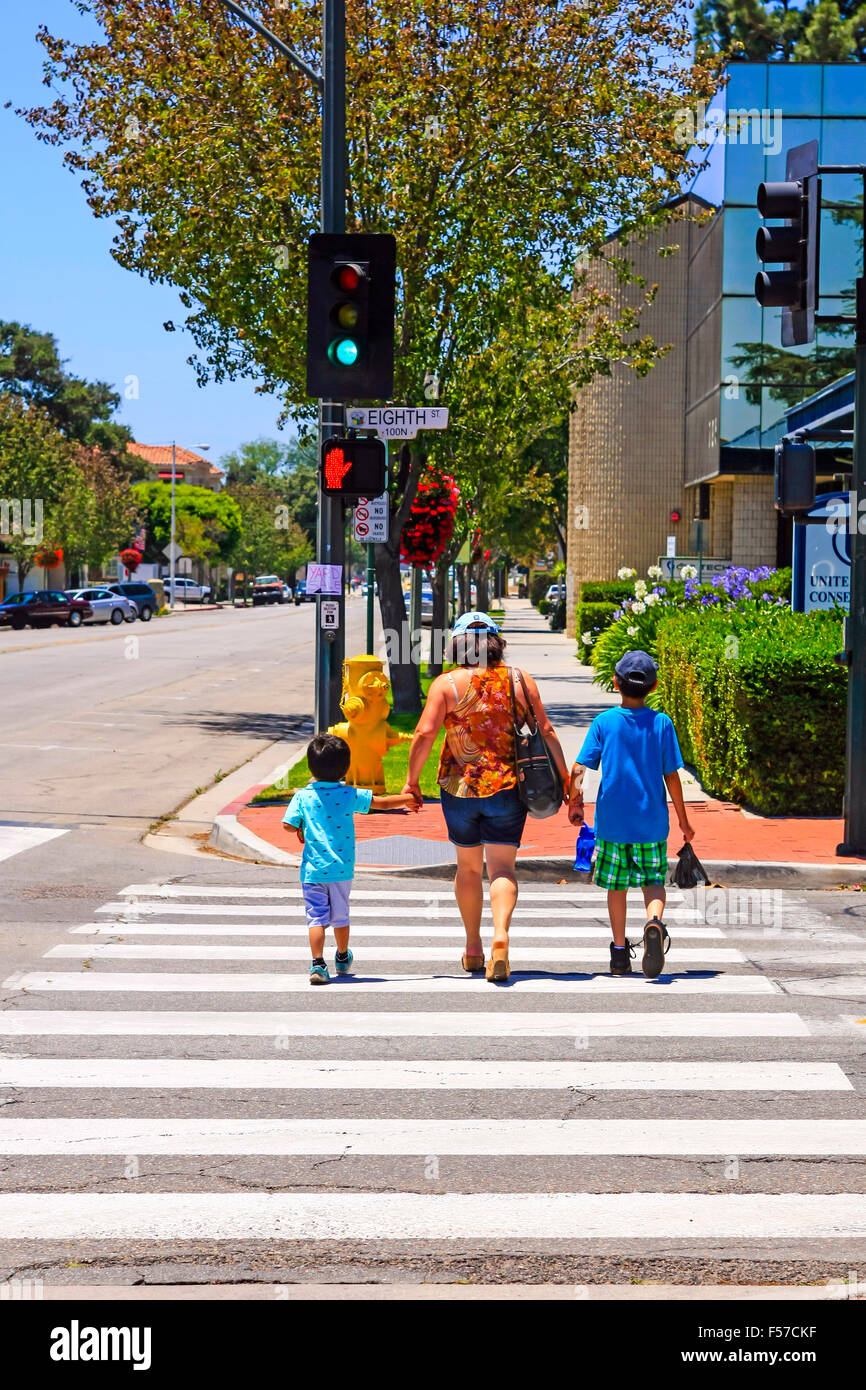 Mother holding children crossing road hi-res stock photography and ...