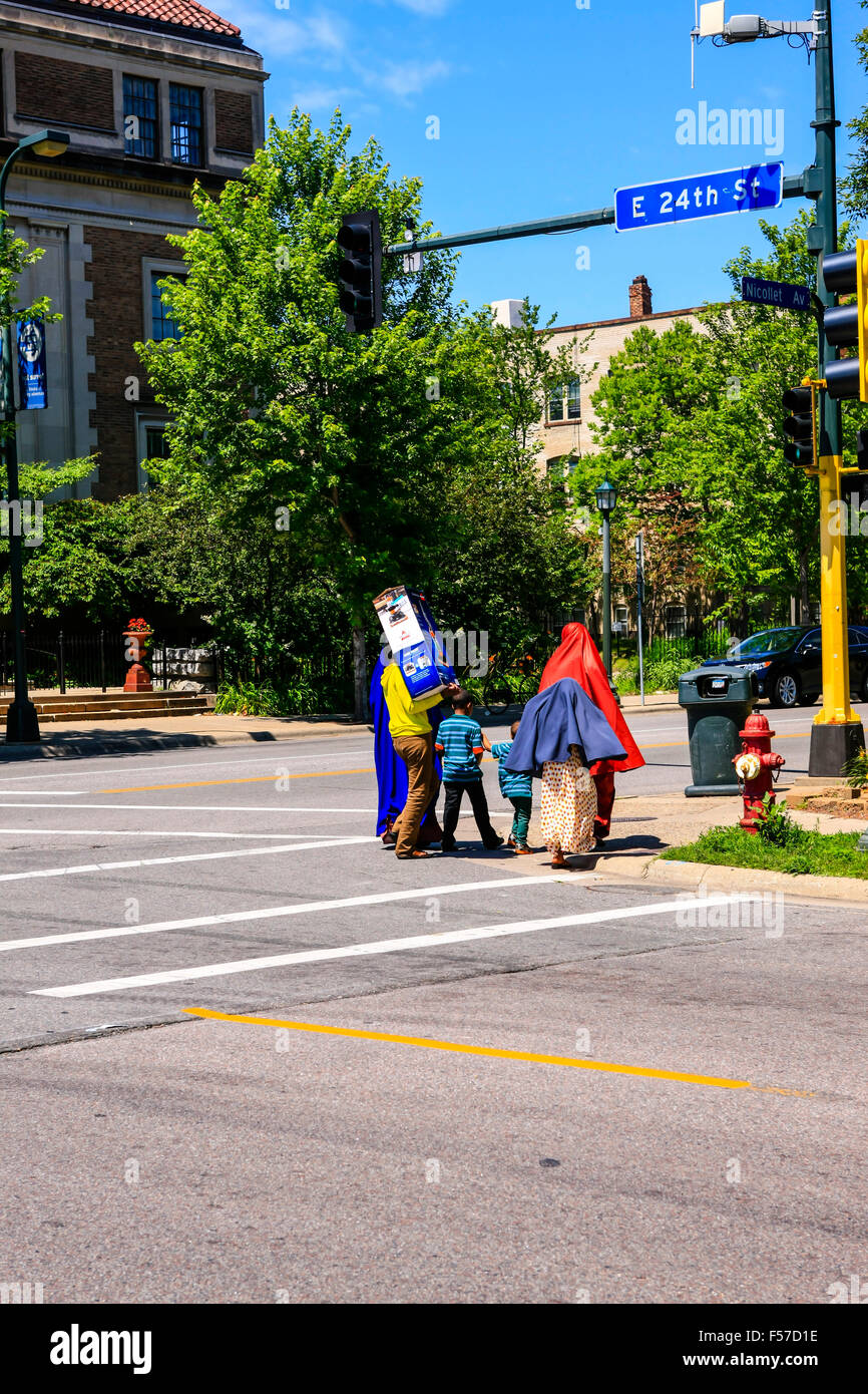 Muslim family using the cross-walk in Minneapolis MN Stock Photo - Alamy