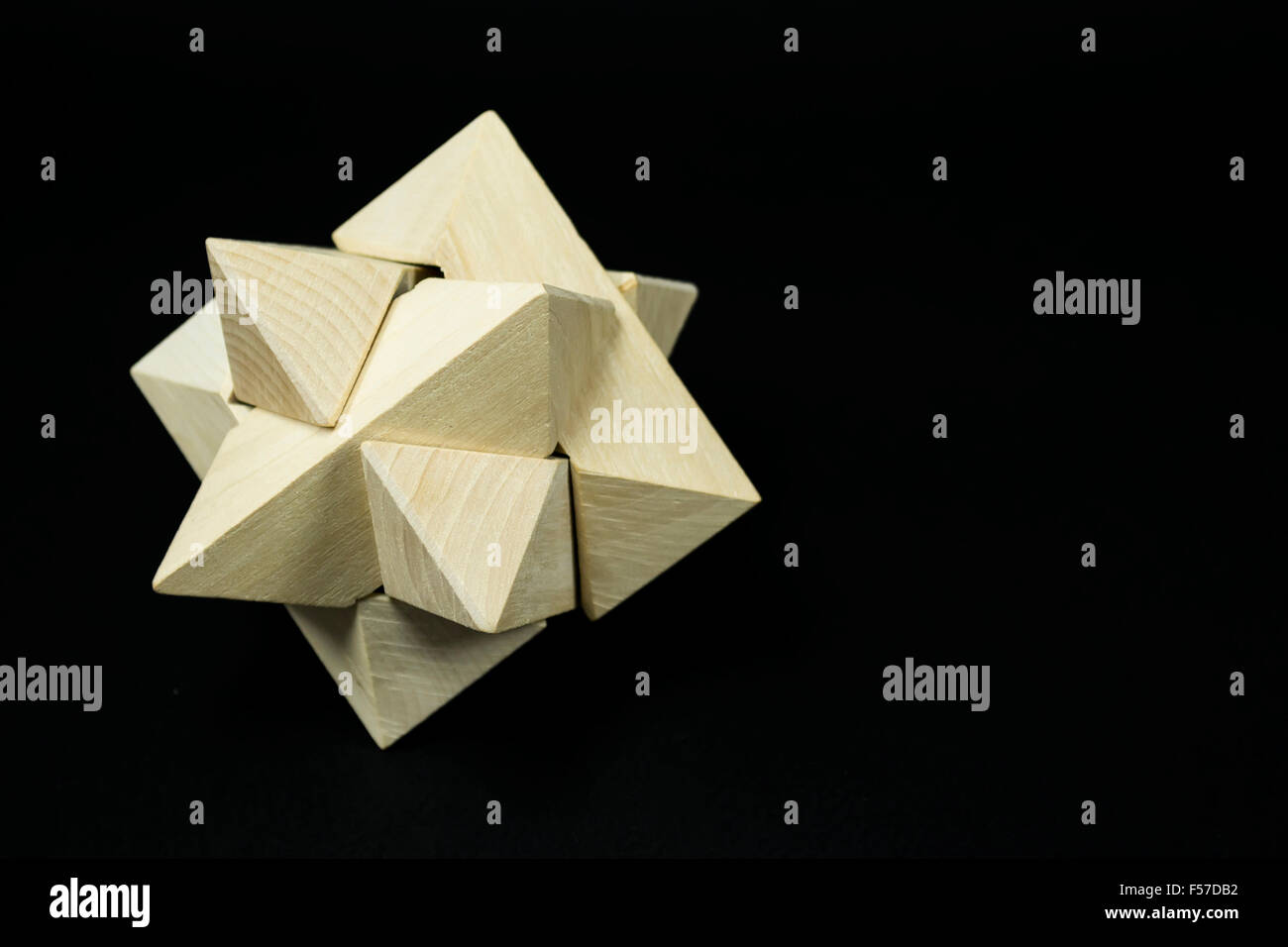 Wooden puzzle from carved tiles combined to form a complex star like ...