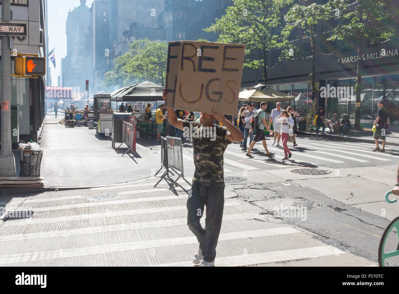 Man walking with hand written sign saying "free hugs" in Manhattan, New ...
