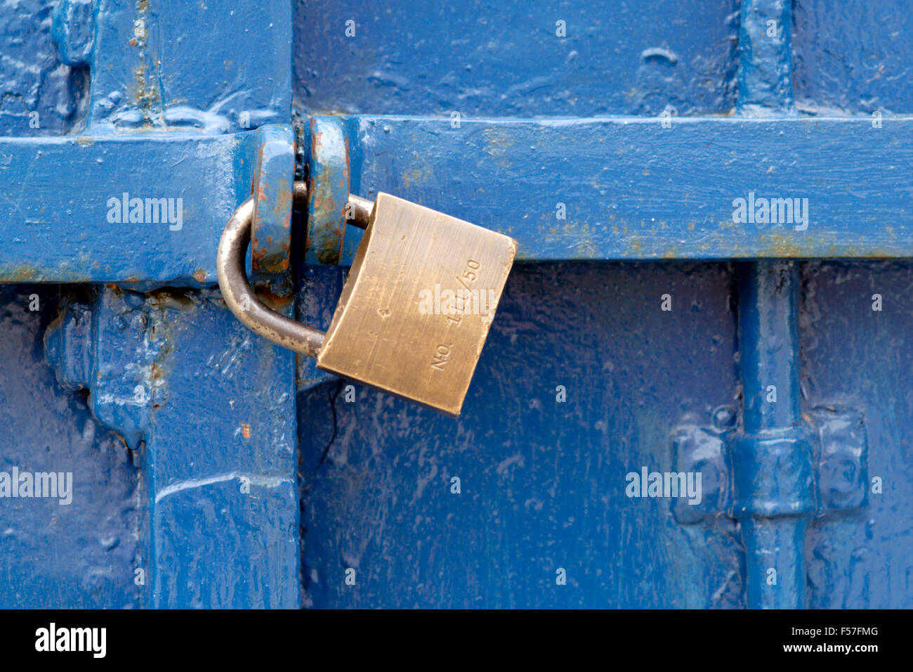 Golden locker on blue metallic door Stock Photo - Alamy