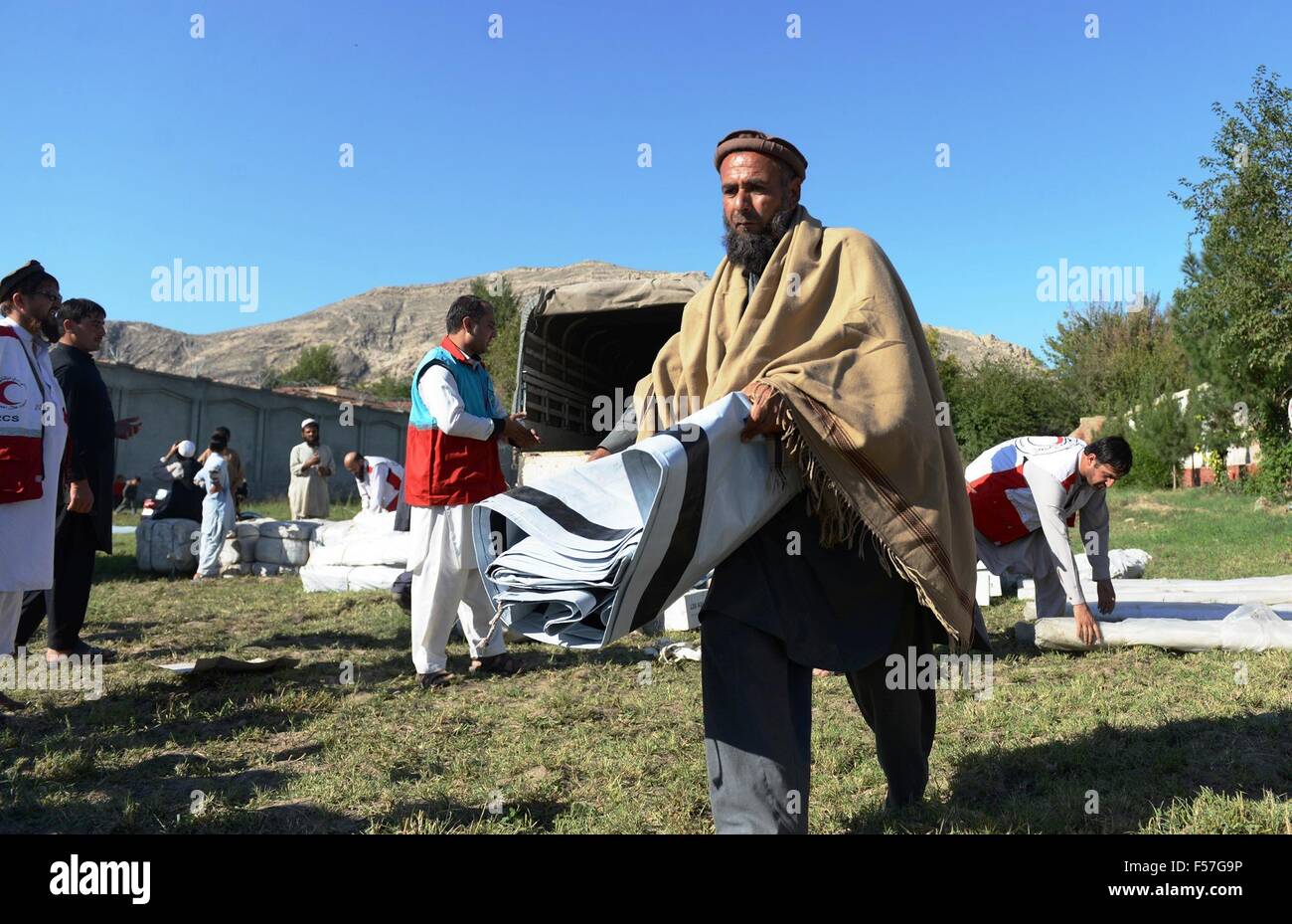 Jalalabad. 29th Oct, 2015. An Afghan man receives relief supplies from ...