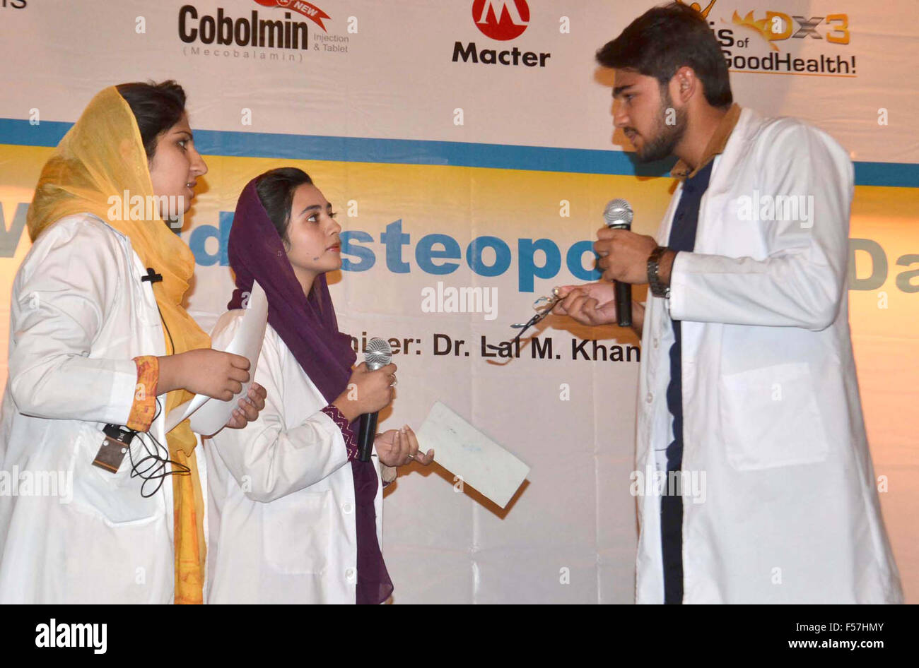 Students perform tableau on stage during seminar on the occasion of ...