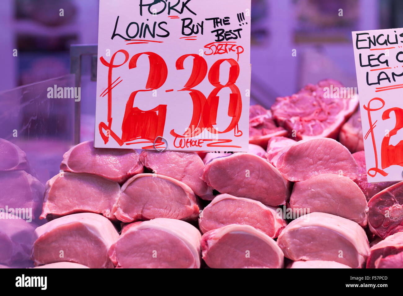 UK, Leeds, Pork loins for sale on a butchers stall in Leeds Market ...