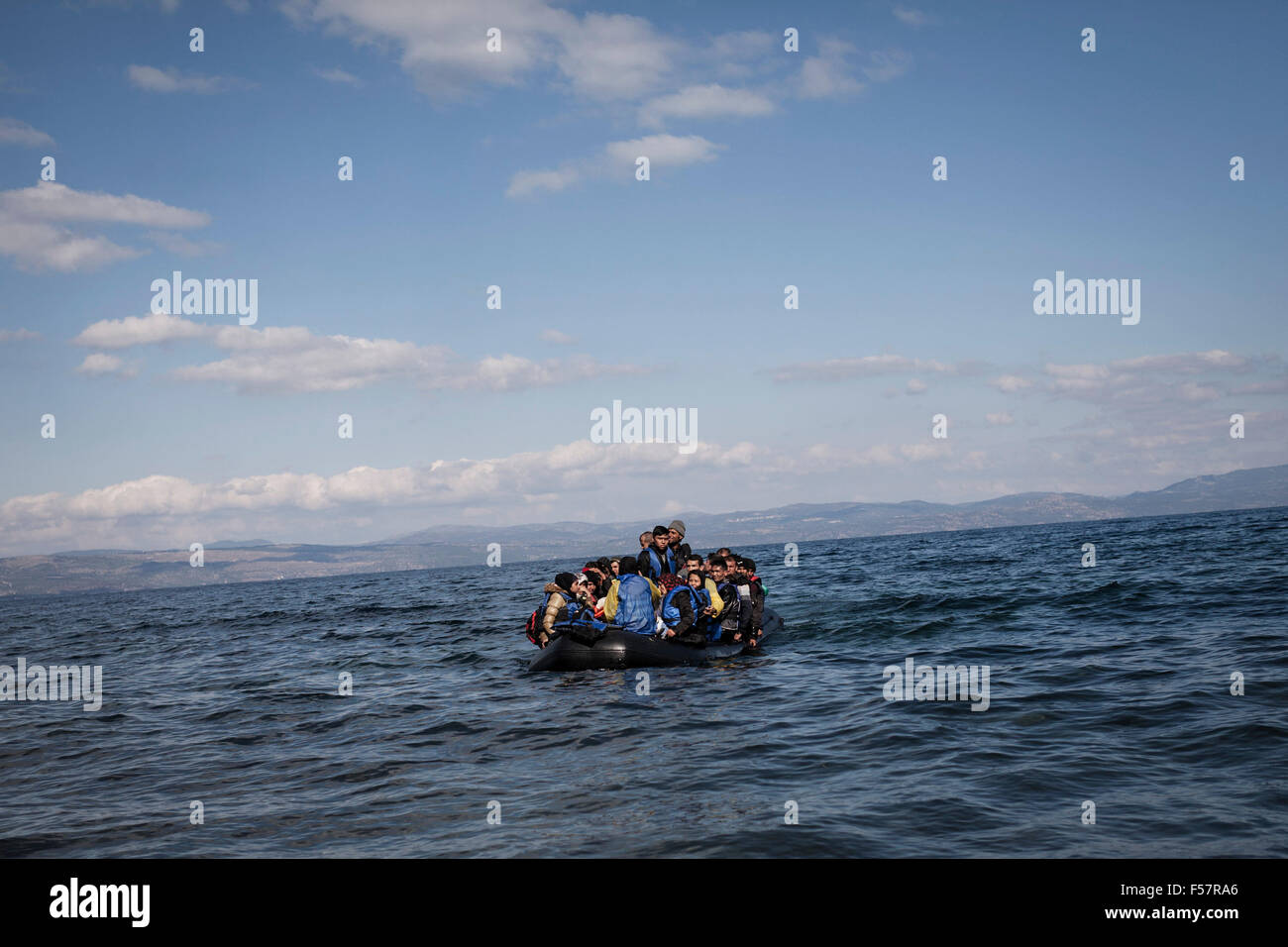 An overcrowded rubber dinghy boat full of refugees and migrants ...