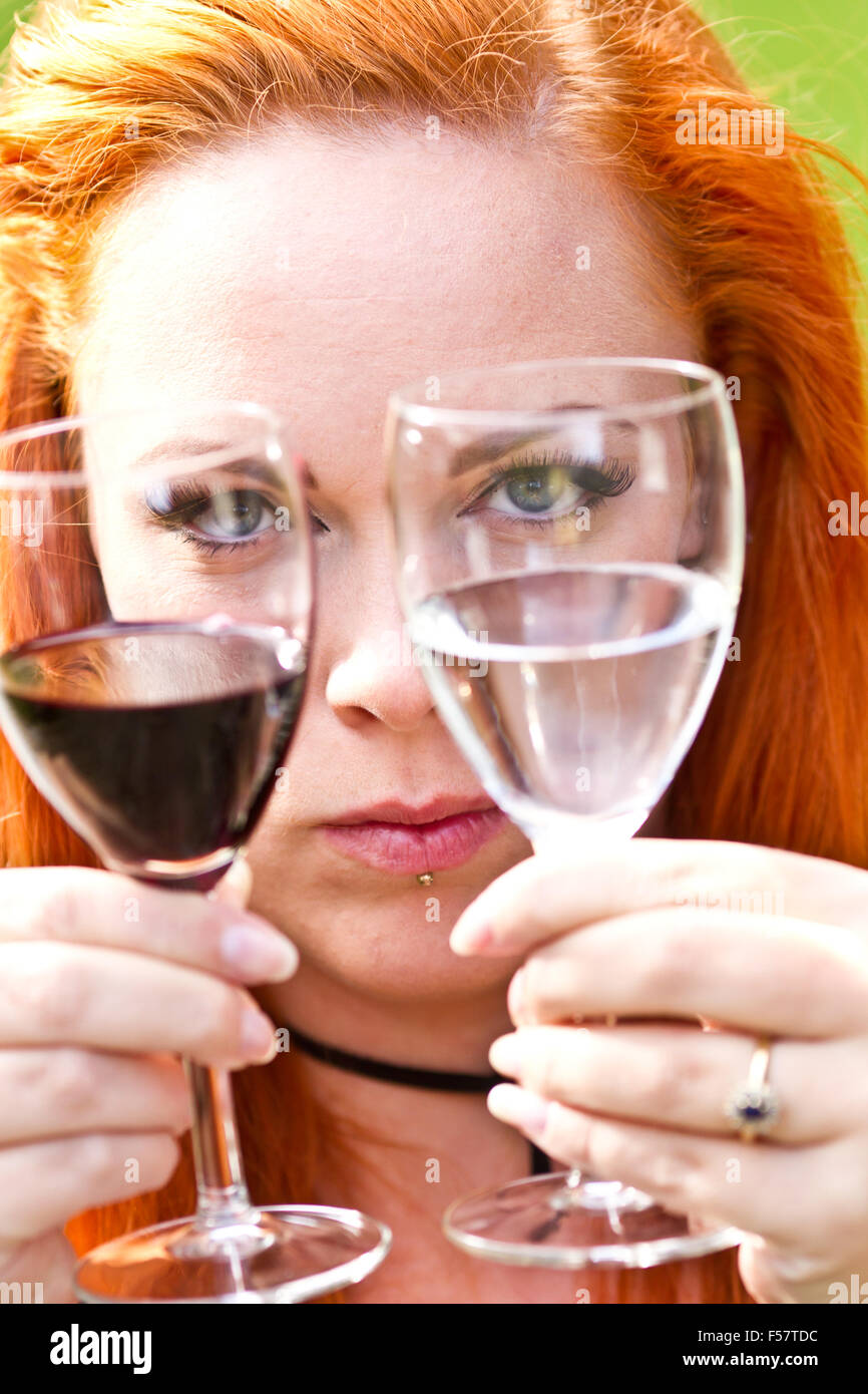 Red hair girl in pin-up style portrait with vine and water glass Stock ...