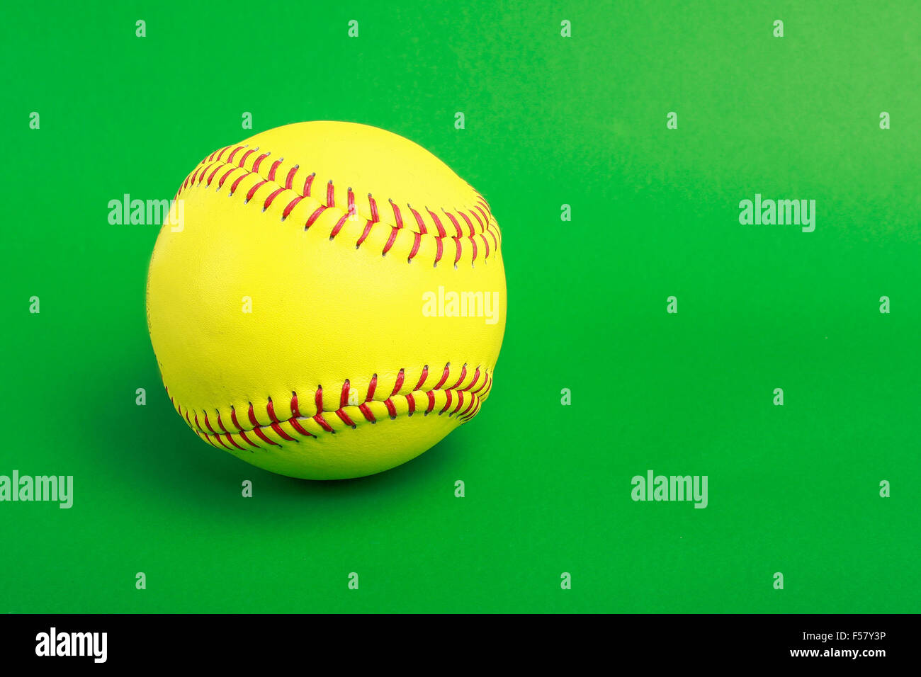 softball ball isolated on green background Stock Photo - Alamy