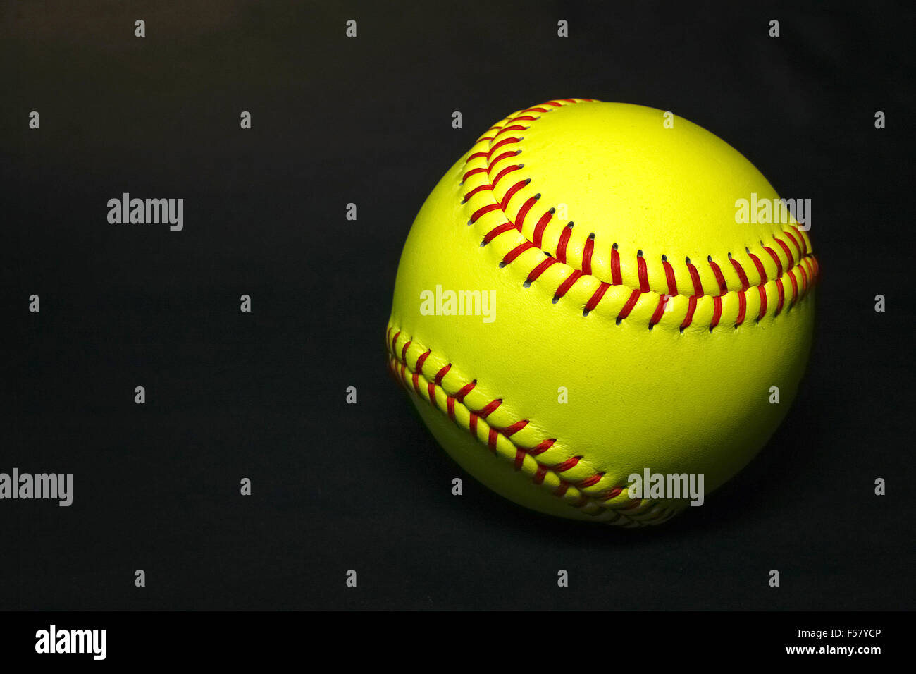 softball ball isolated on dark background Stock Photo - Alamy